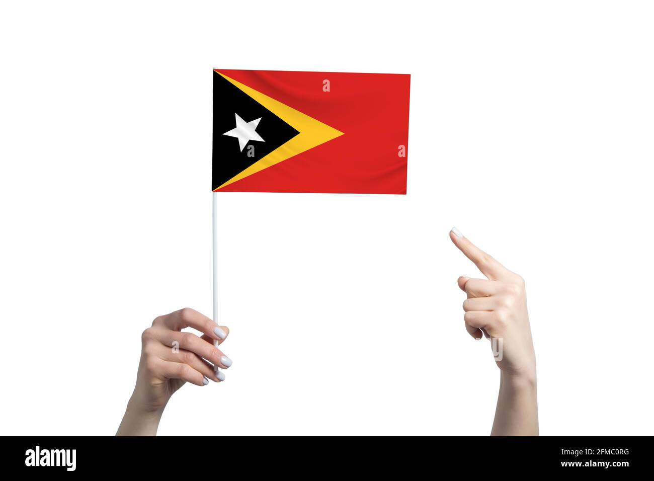 A beautiful female hand holds a East Timor flag to which she shows the ...