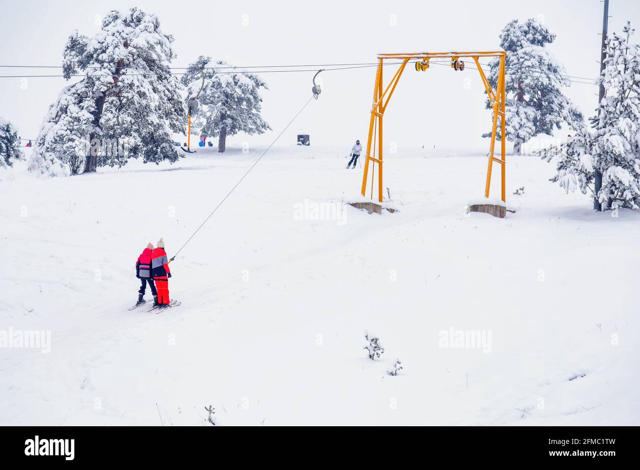 Kids using surface ski lift going uphill, outdoor fun activities ...