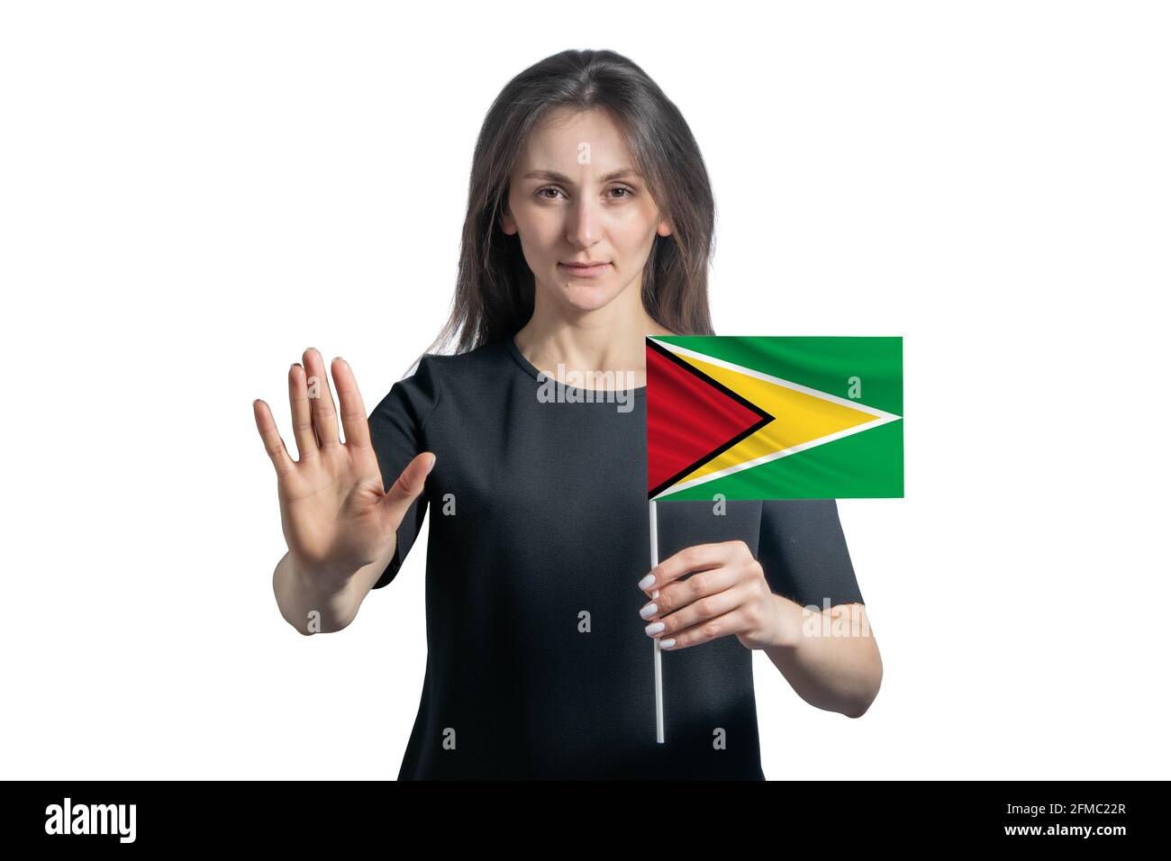Happy young white woman holding flag of Guyana and with a serious face ...