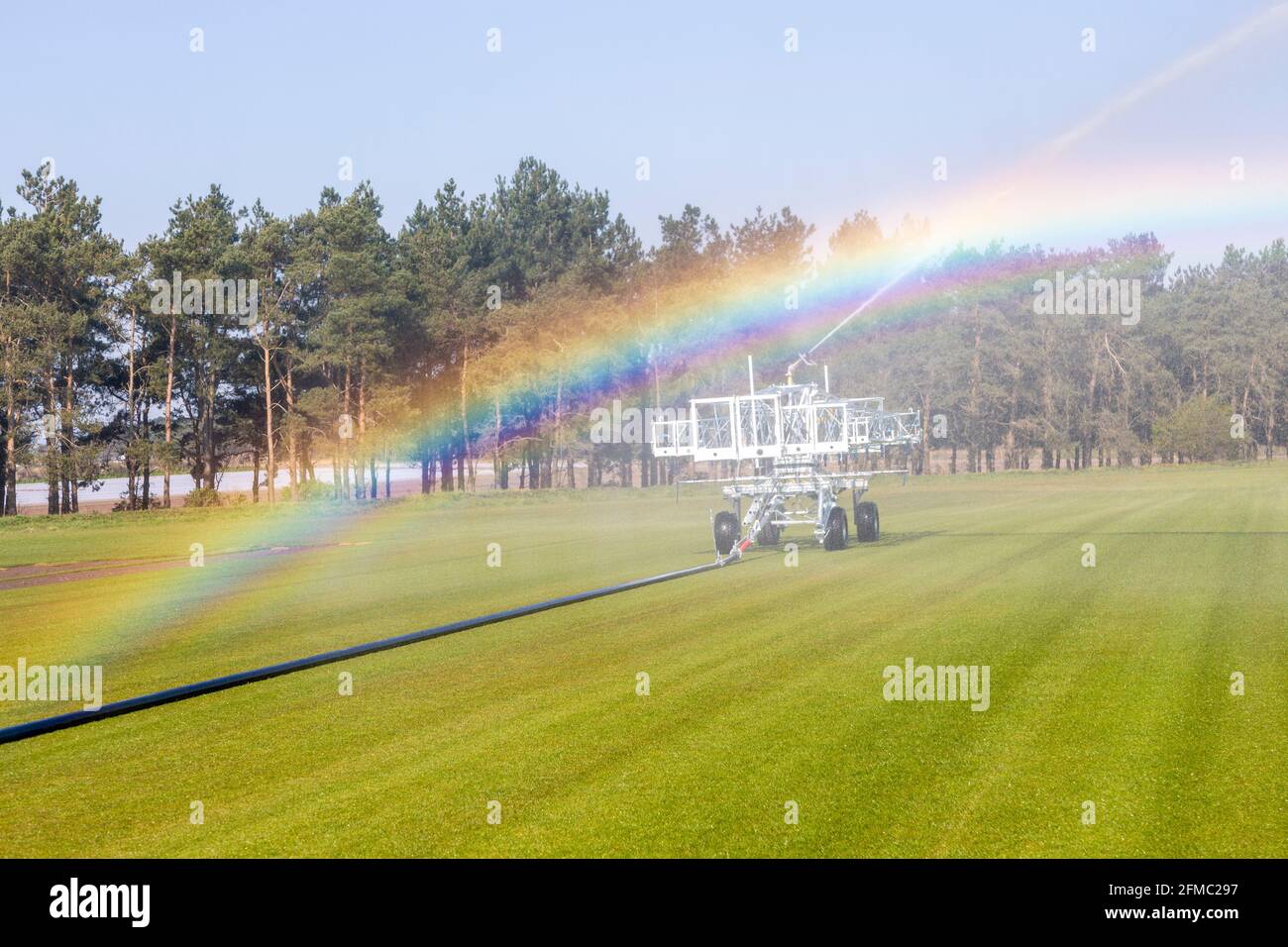 Irrigator machine spraying water turf farming, Sutton Heath, Suffolk ...