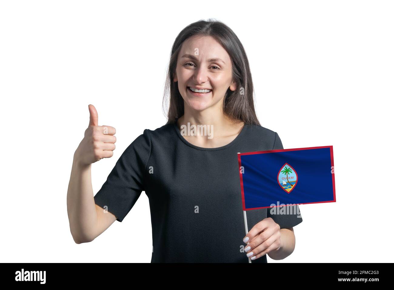 Happy young white woman holding flag of Guam and shows the class by ...