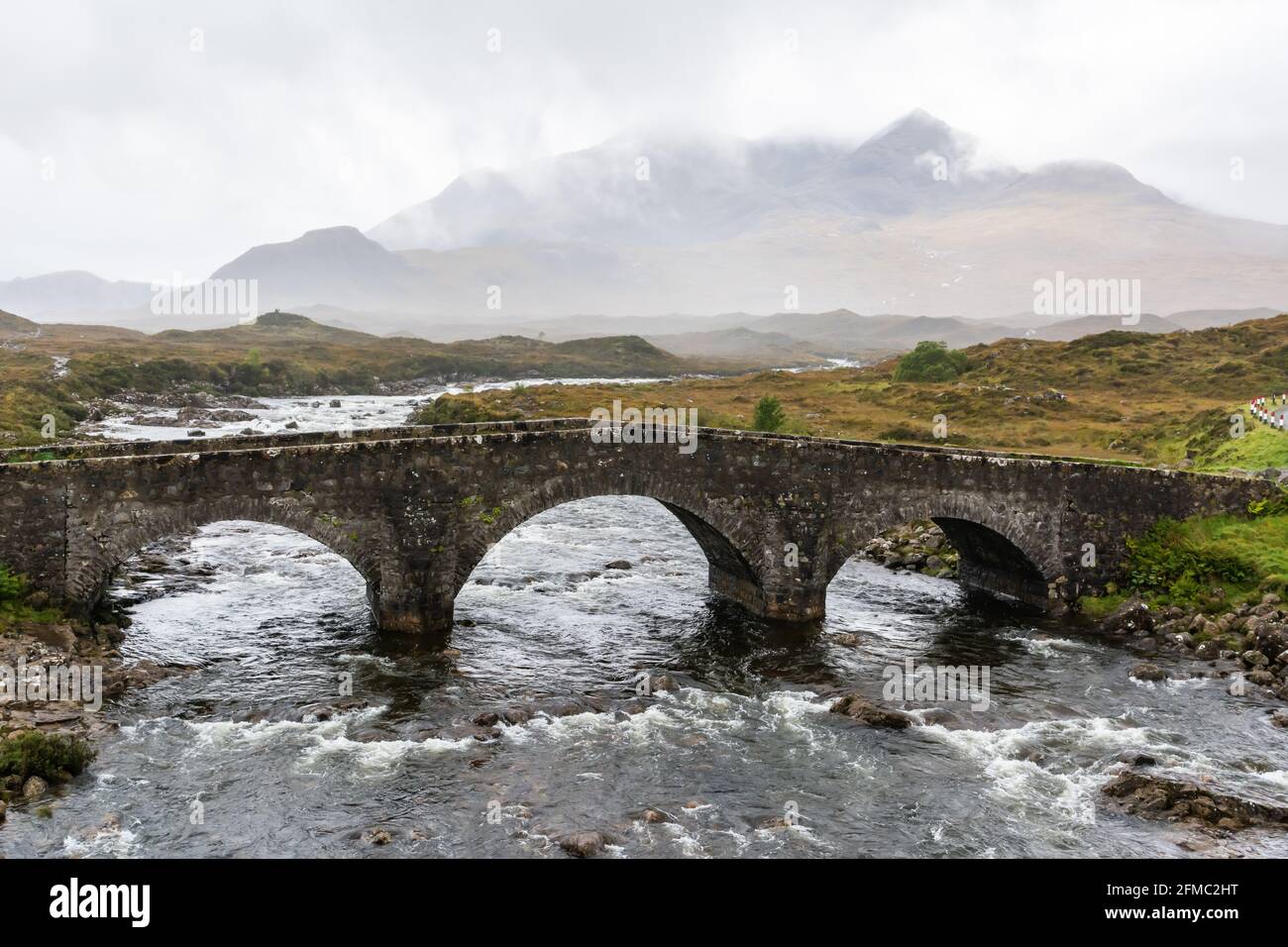 Old three-arched stone bridge over the River Sligachan in the Isle of ...