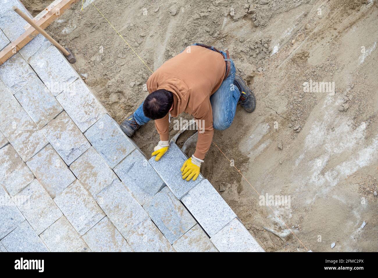Riverbank erosion control, stone wall installing Stock Photo - Alamy