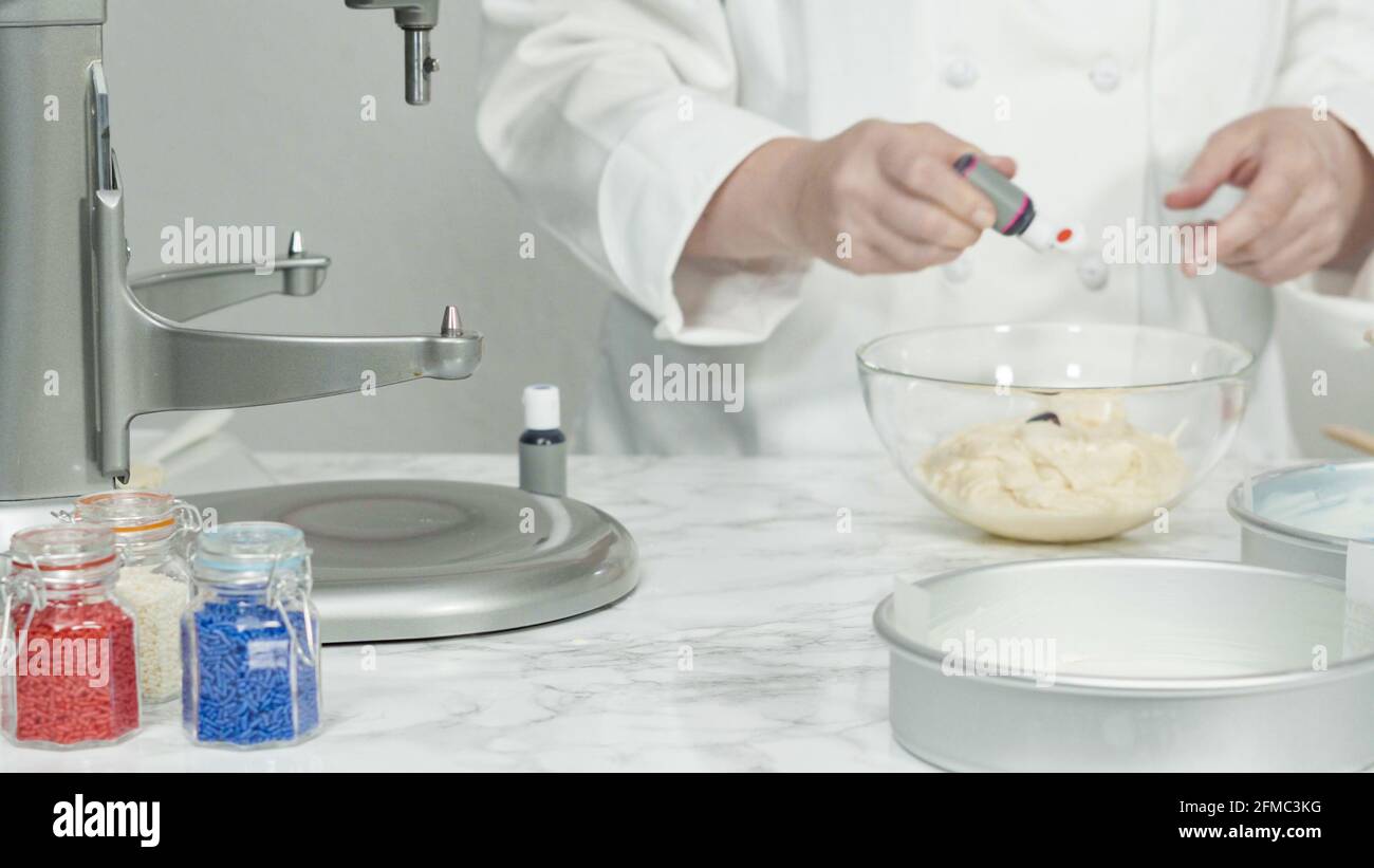 Step by step. Mixing food coloring into a cake batter to bake a three ...