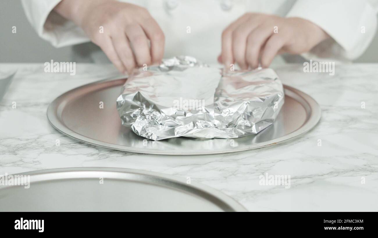Step by step. Wrapping freshly baked cake layers into clear food wrap ...