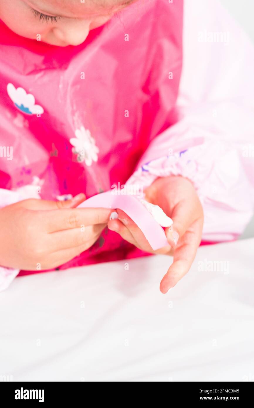 Little girl modeling mermaid tails with white air-dry modeling clay ...
