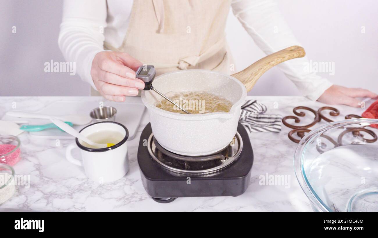 Step by step. Caramelizing sugar in a small cooking pot over the small ...