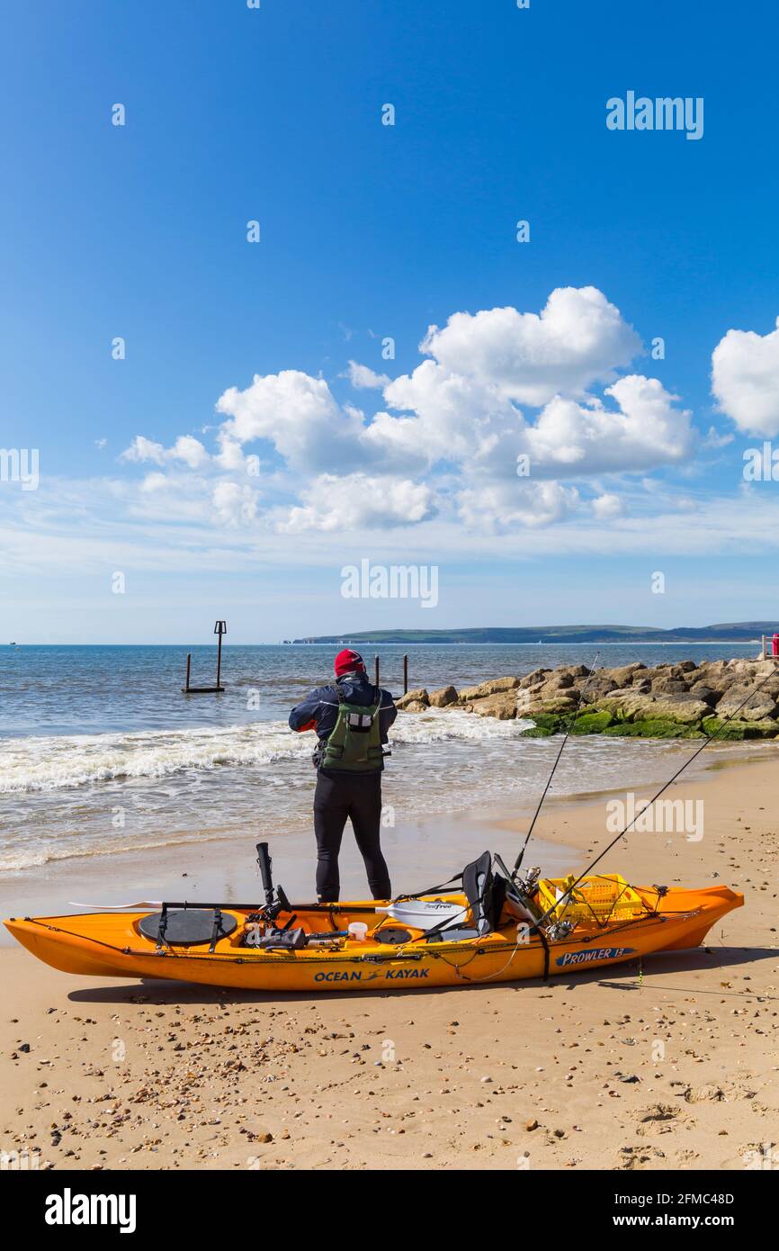 getting ready to go kayak fishing in the sea at Poole, Dorset UK in May ...