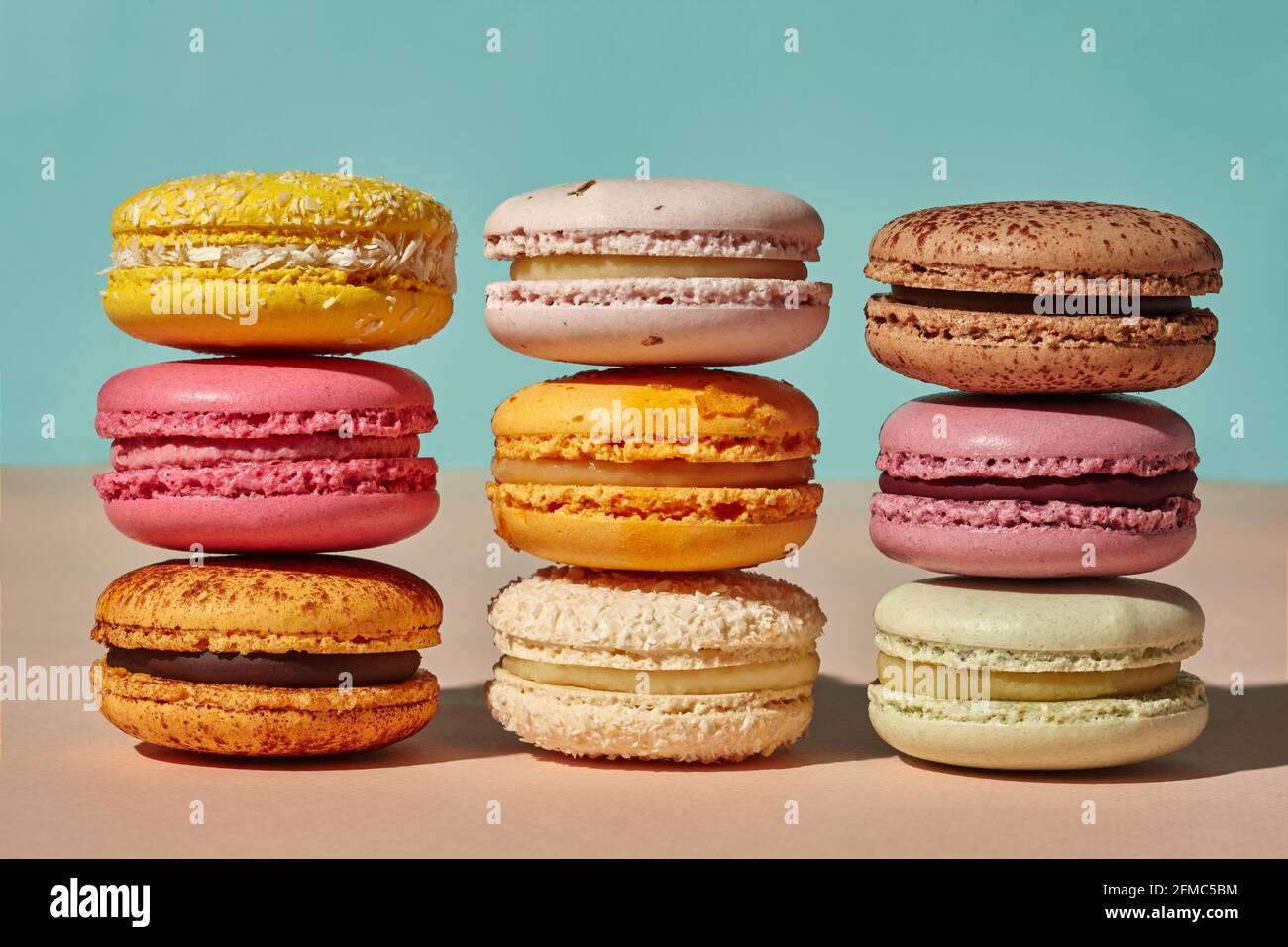 Three stacks of macarons on pink and blue background Stock Photo - Alamy