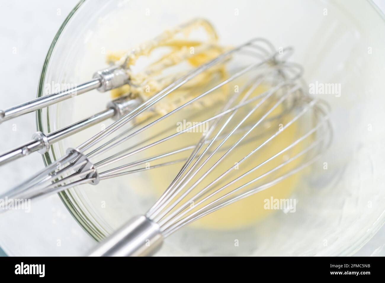 Dirty whisks in a glass mixing bowl after baking a cake Stock Photo - Alamy