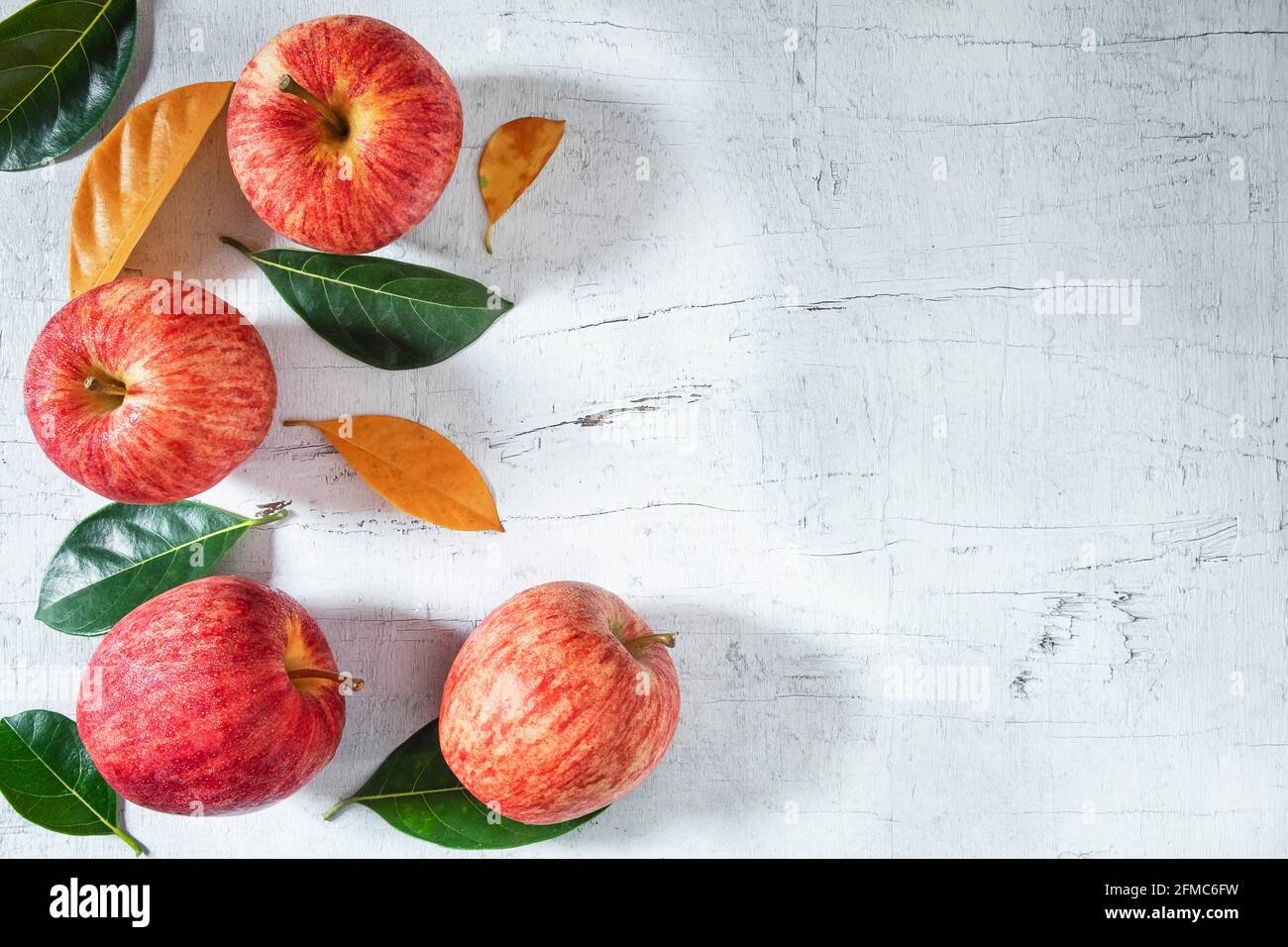 Fresh apple fruit on a white wood table Stock Photo - Alamy