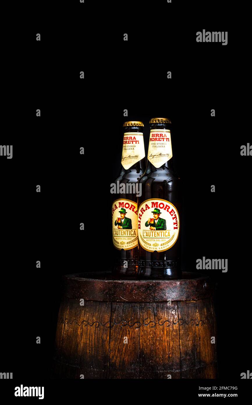 Bottle of Birra Moretti beer on wooden barrel with dark background ...