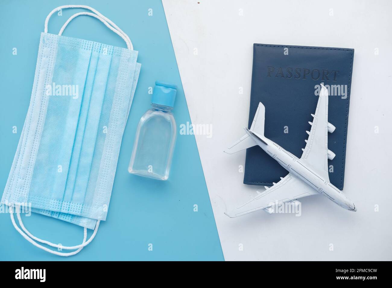 protective mask, airplane and blue color passport on table Stock Photo ...