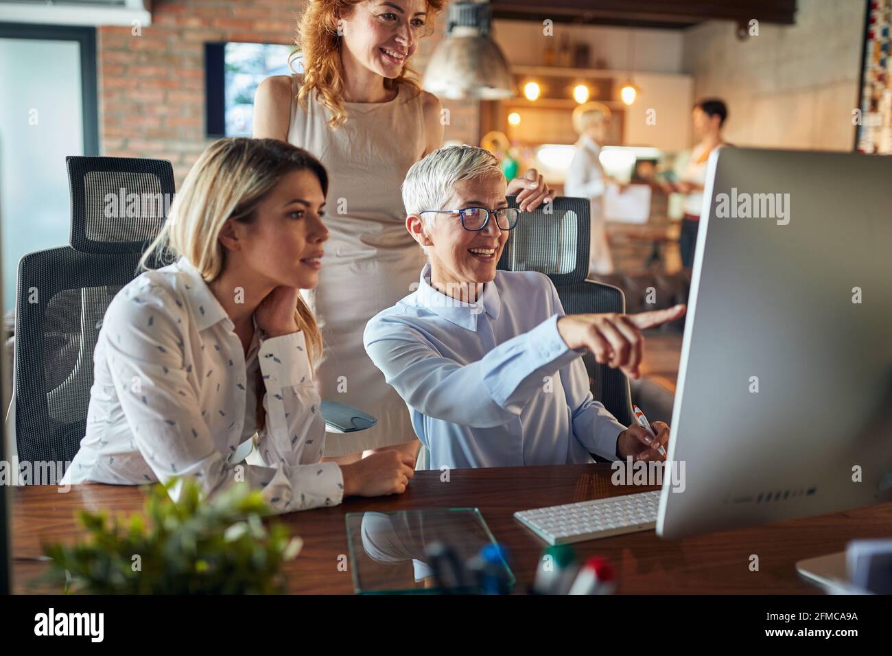 Group people watching computer screen hi-res stock photography and ...