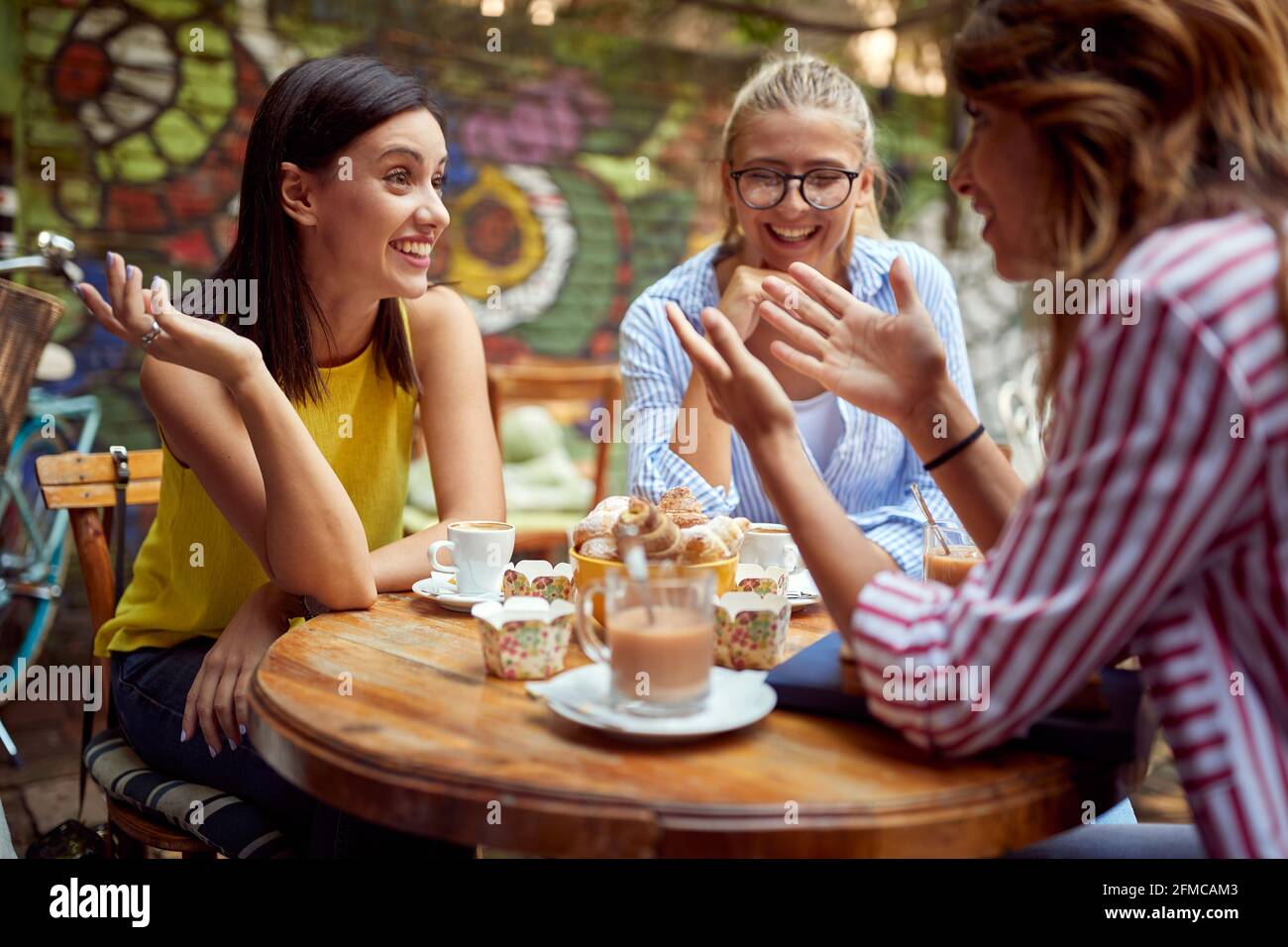 A group of female students is enjoying a friendly talk while having a ...