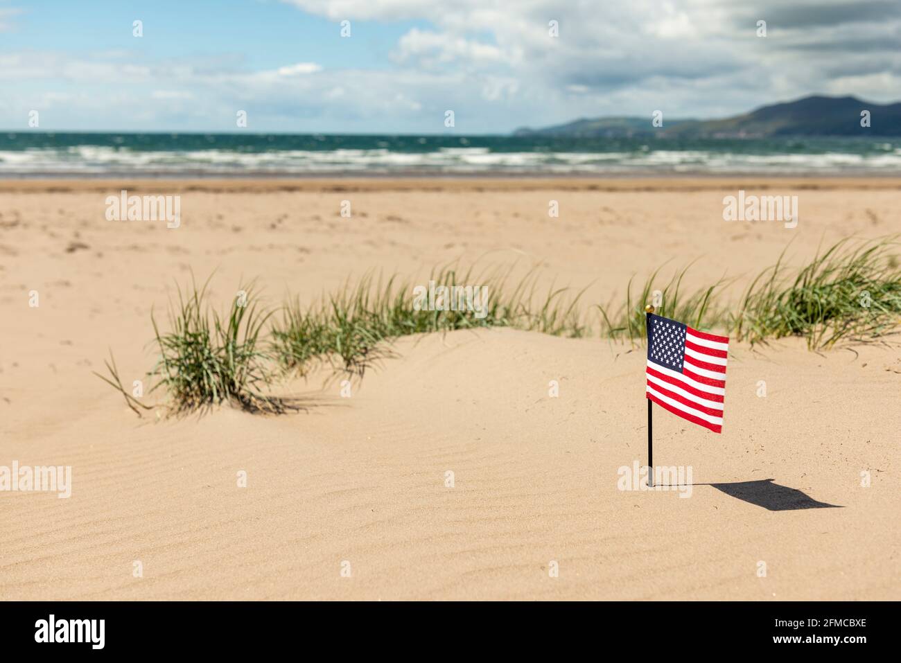 American flag and beach. US flag and vast empty sandy beach with open ...