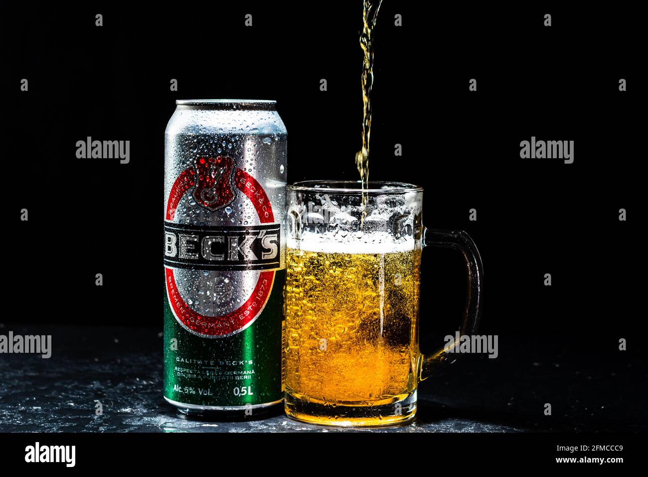 Can of Beck`s or Becks beer and beer glass on dark background ...