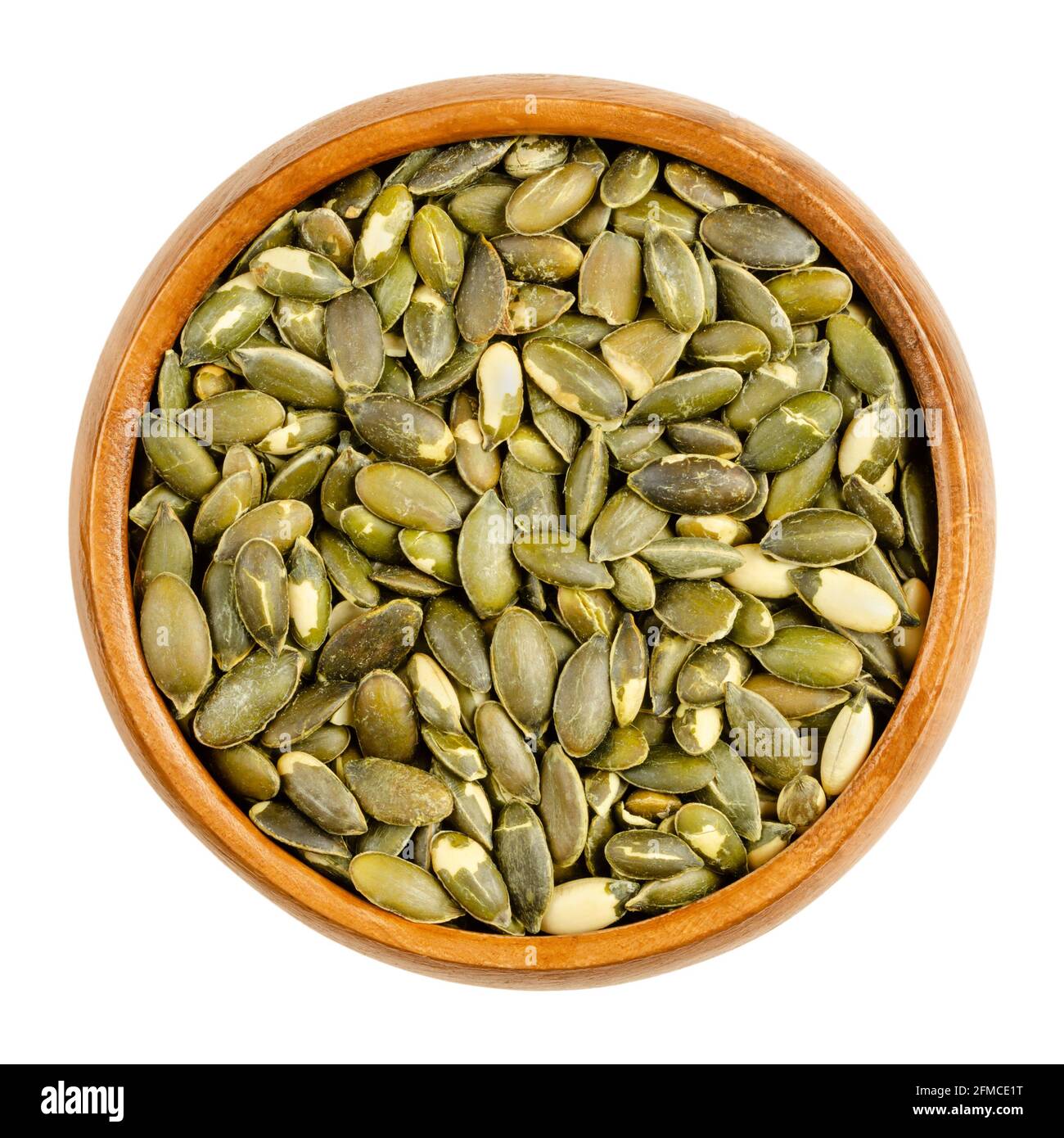 Hulled, roasted, salted pumpkin seeds, in a wooden bowl. Edible, flat ...