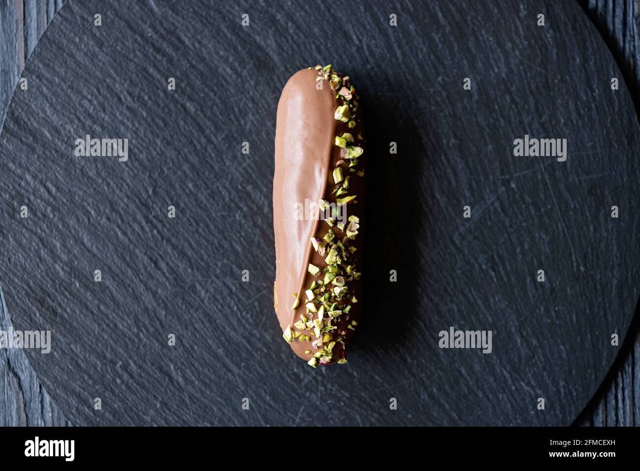 French dessert eclairs or profiteroles with milk chocolate glaze and ...