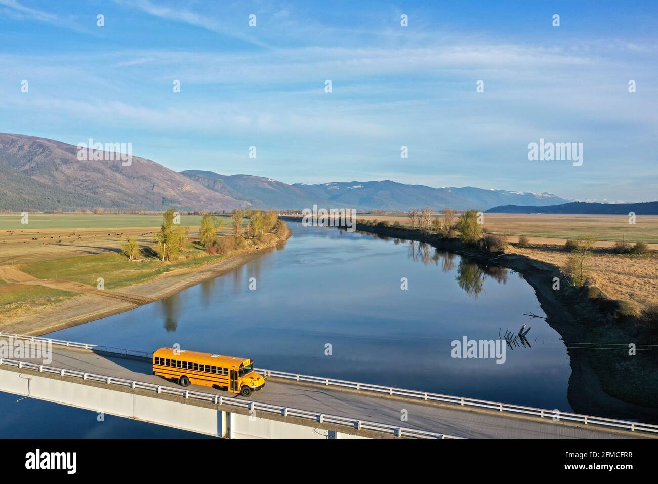 School bus traveling over the Kootenai River in spring at Copeland ...