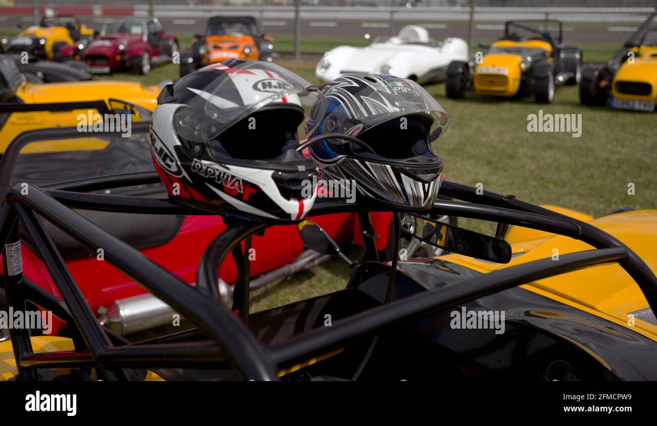 Two crash helmets wait patiently for their owners to return in a group ...
