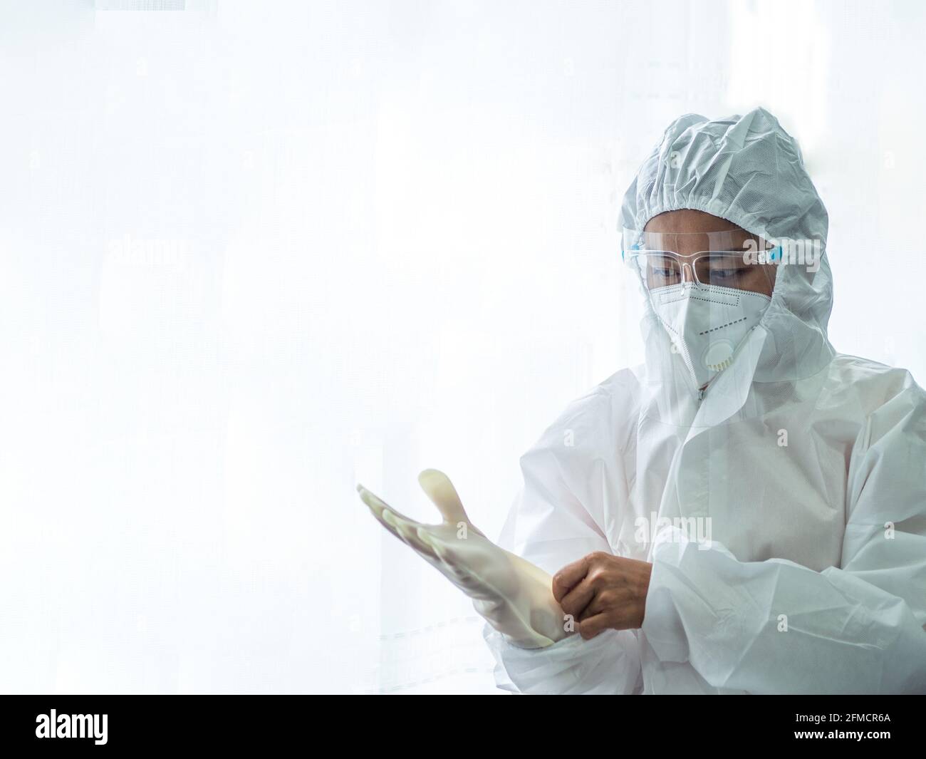 woman doctor in PPE (Personal Protective Equipment) for working in ...