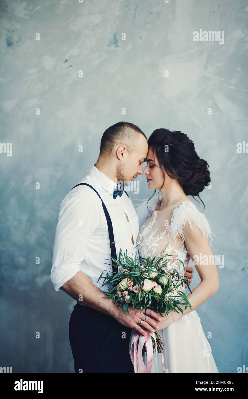 The bride and groom hugging in studio Stock Photo - Alamy