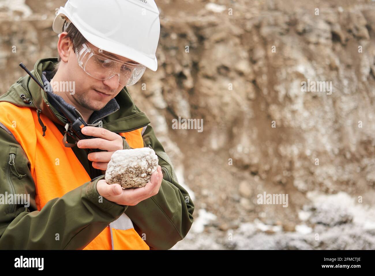 man geologist examines a mineral sample Stock Photo - Alamy