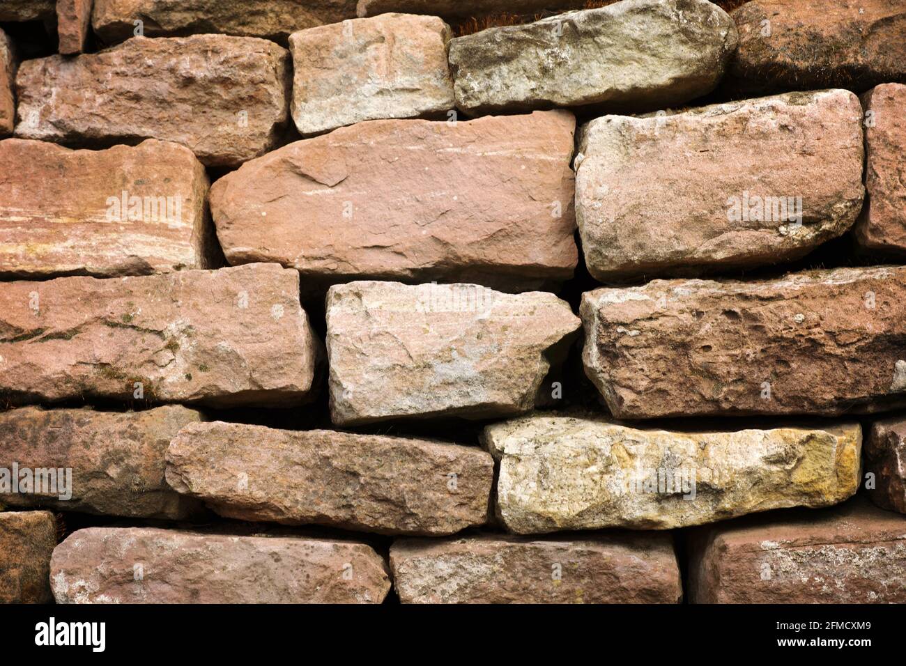 Background stone wall made of red stones Stock Photo - Alamy