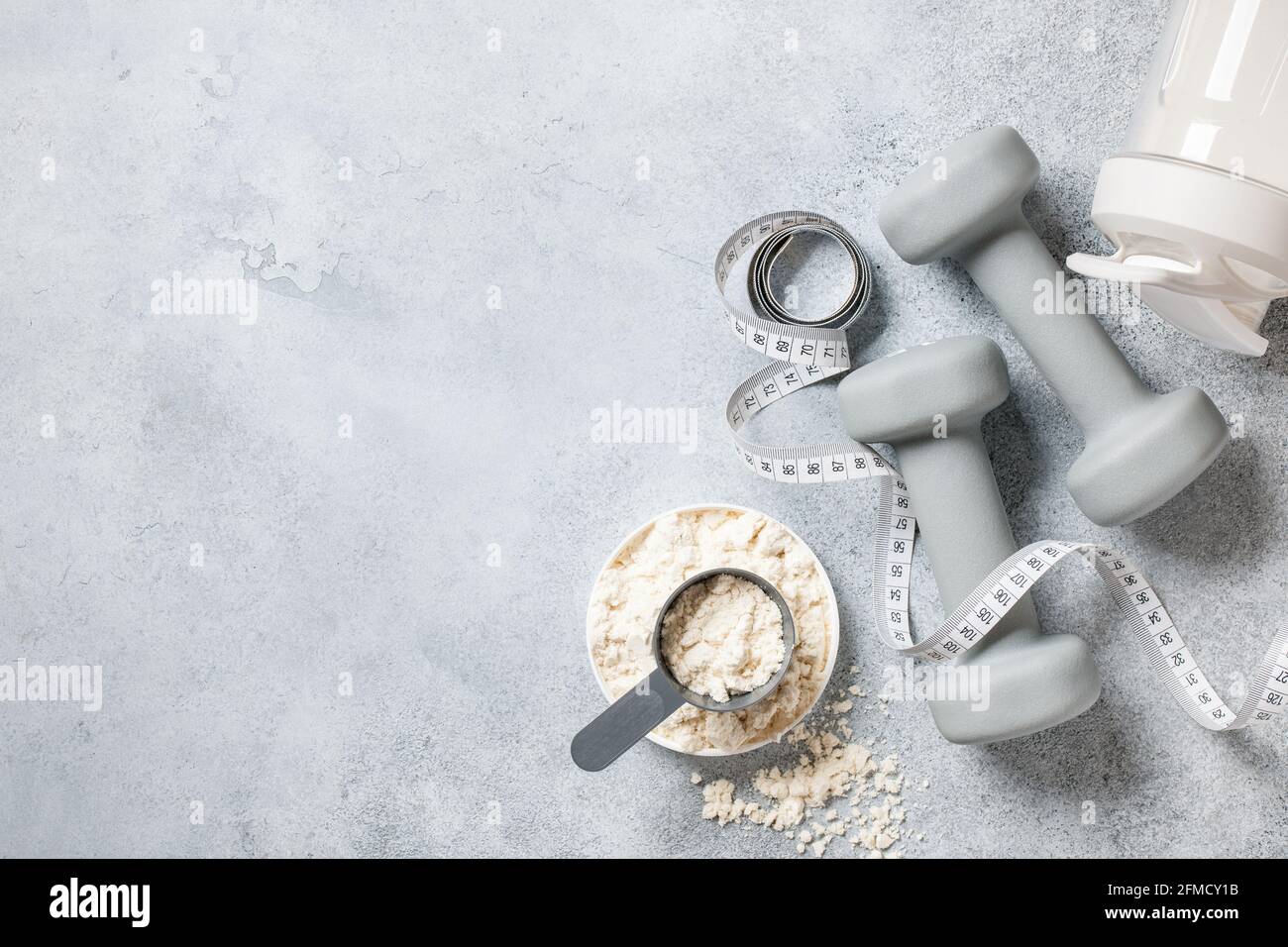 Whey protein powder, shaker with protein cocktail and dumbbells Stock ...