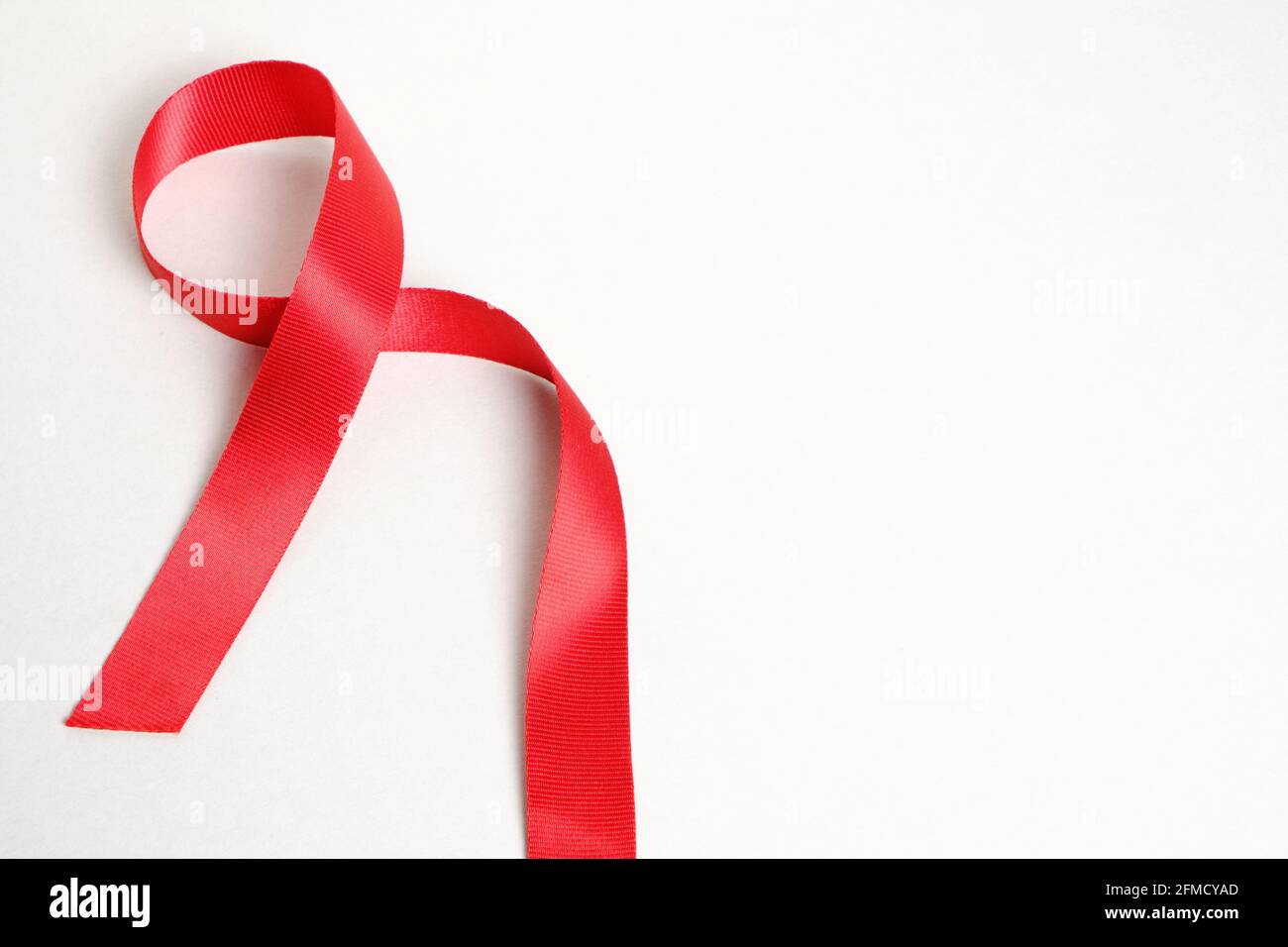 Red ribbon twisted in a spiral on a white background Stock Photo - Alamy