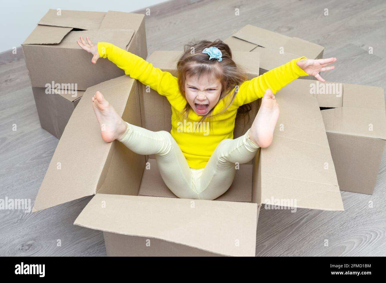angry little girl doesn't want to crawl into a new apartment. child in ...