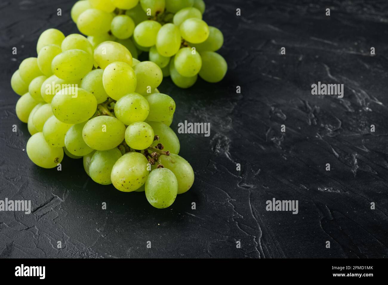 Finest natural home bunch of grapes set, green fruits, on black stone ...