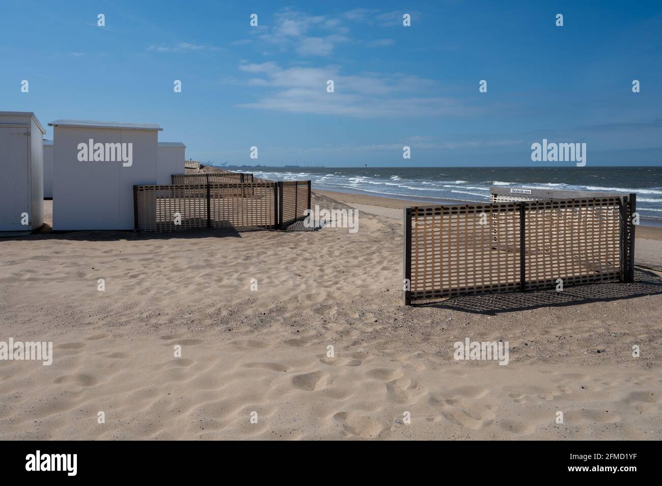 White beach huts on yellow sandy beaches in small Belgian town Knokke ...