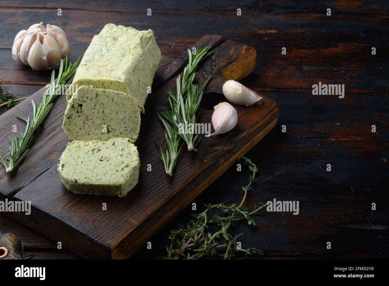 Dairy green butter with herbs set, on old dark wooden table background ...