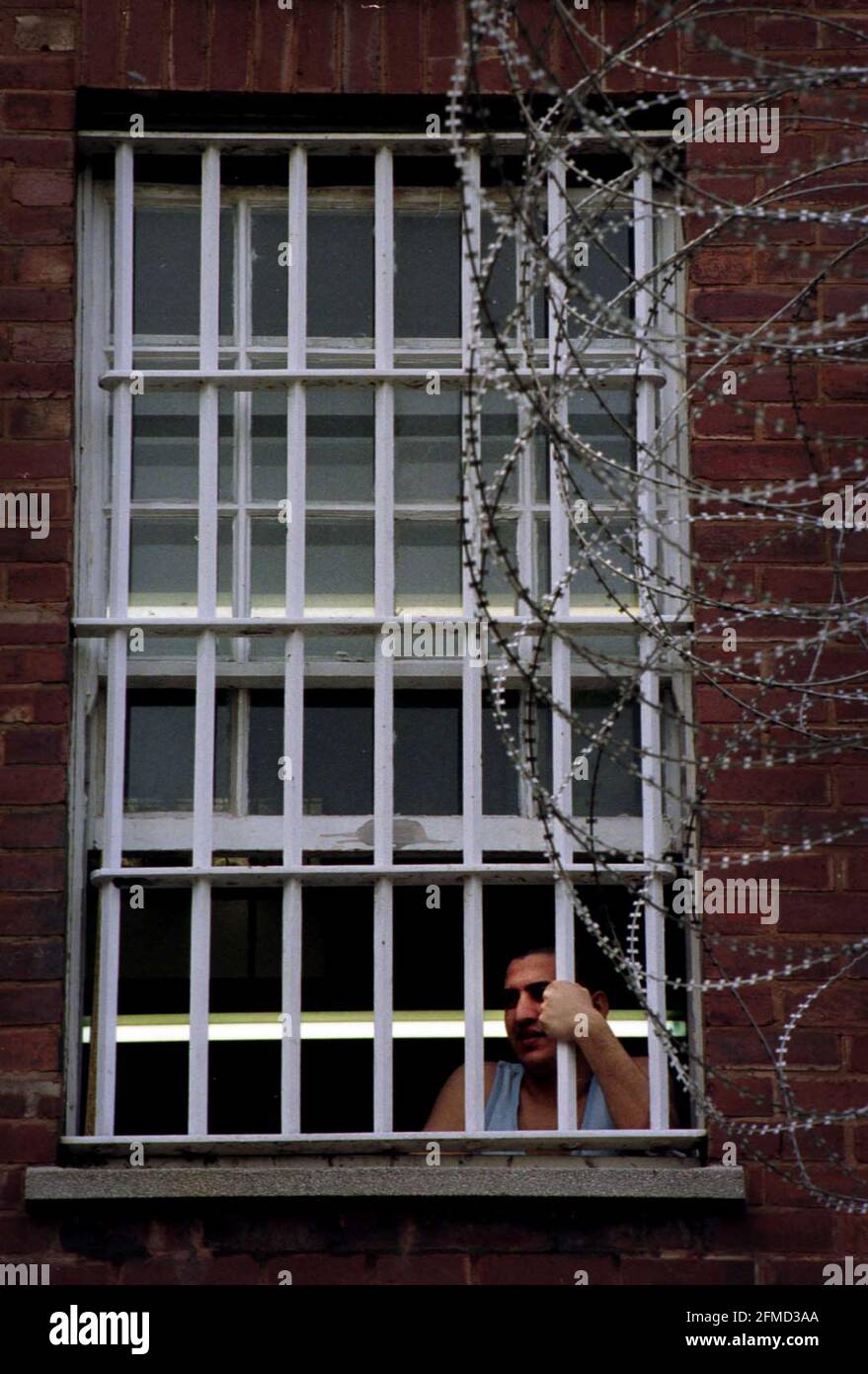 Winson Green Prison, Birmingham March 2001 an inmate leans on the white ...