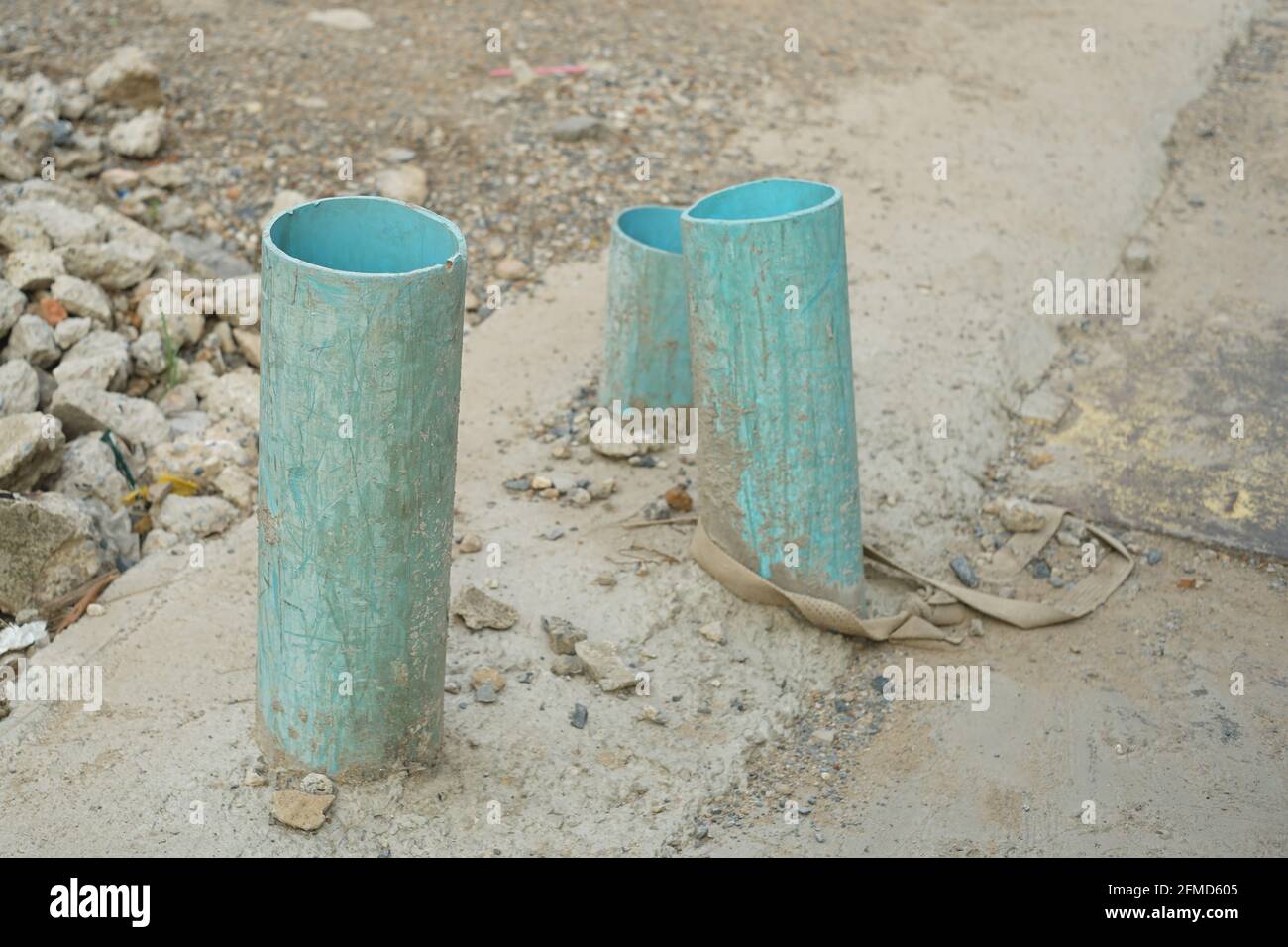 A blue plastic pipe is buried on the corridor prepare for the ...
