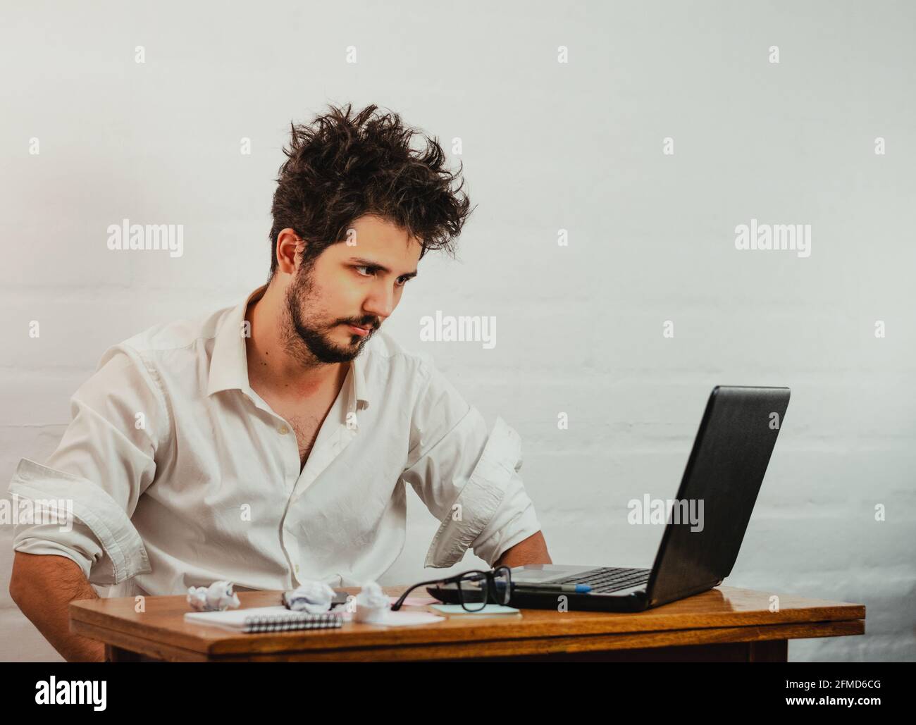 Pensive man staring laptop hi-res stock photography and images - Alamy