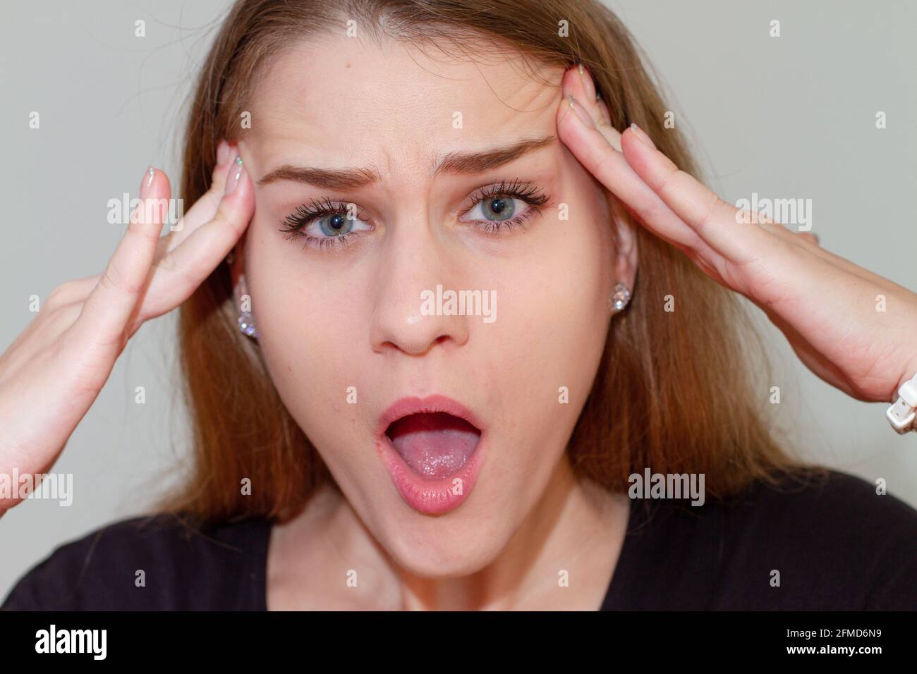Nervous screaming woman is having a terrible headache Stock Photo - Alamy