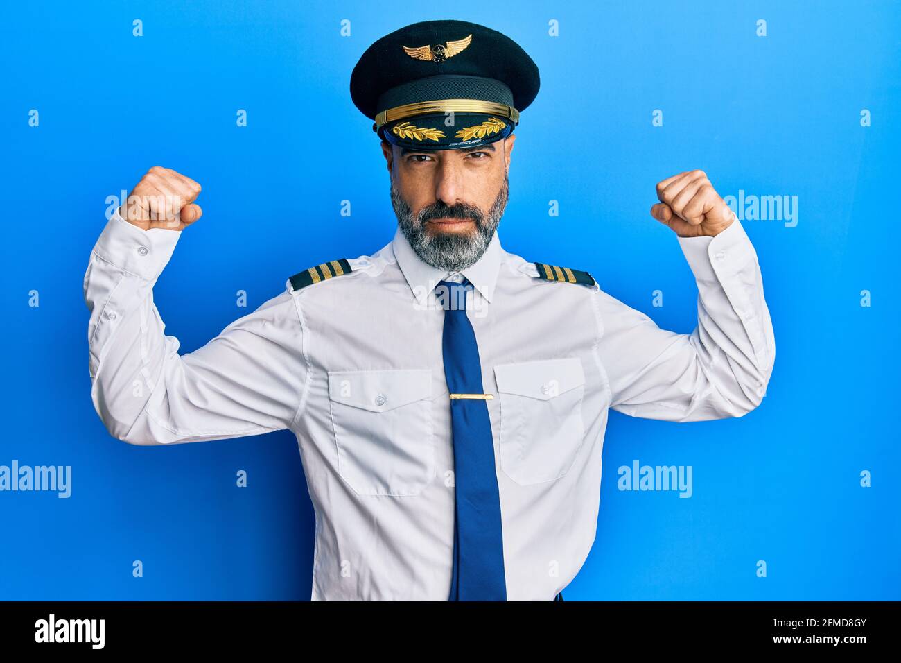 Middle age man with beard and grey hair wearing airplane pilot uniform ...