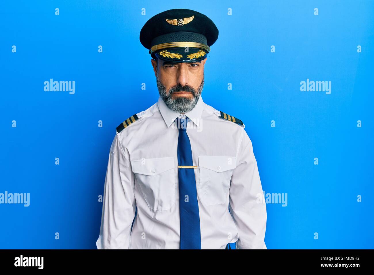 Middle age man with beard and grey hair wearing airplane pilot uniform ...