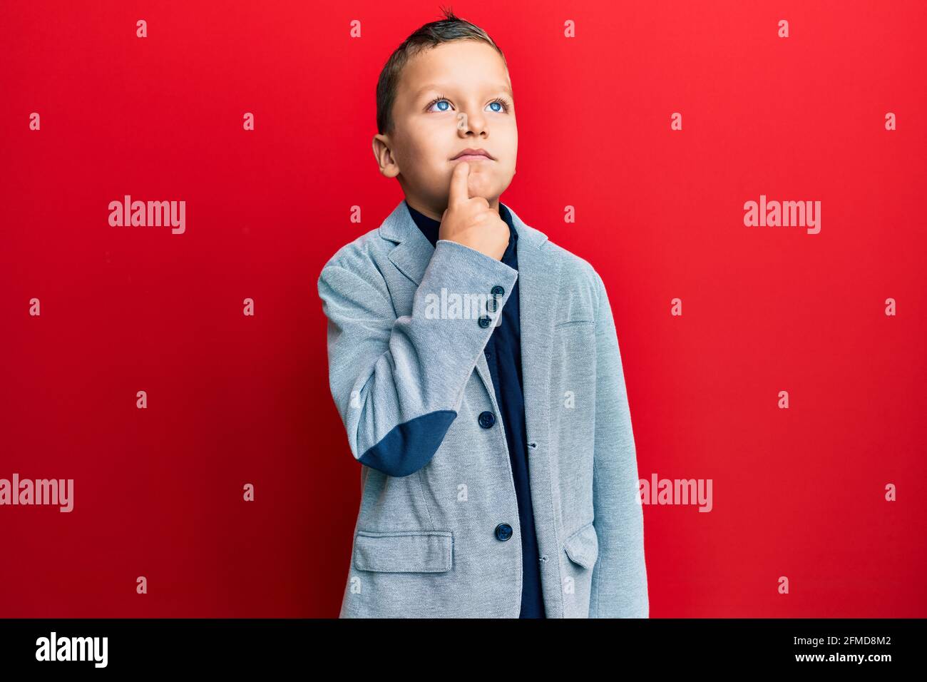 Little kid boy wearing elegant business jacket thinking concentrated ...