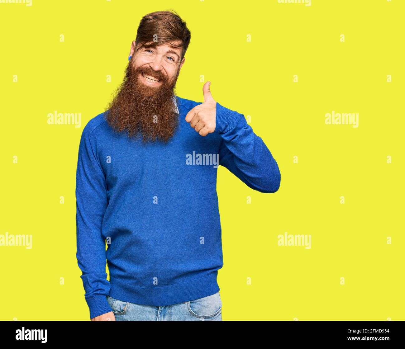 Young irish redhead man wearing casual clothes doing happy thumbs up ...