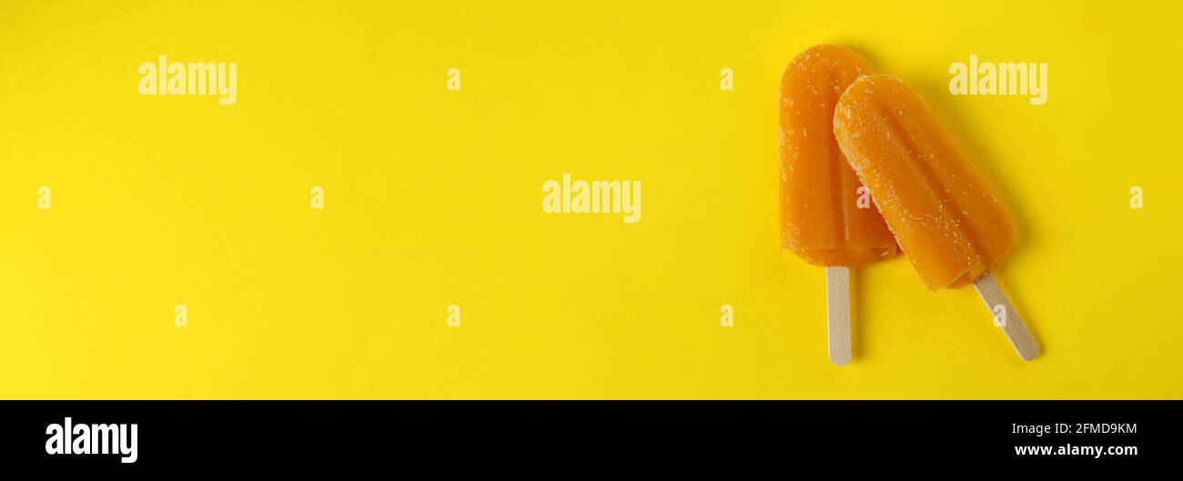 Mango ice cream sticks on yellow background Stock Photo - Alamy