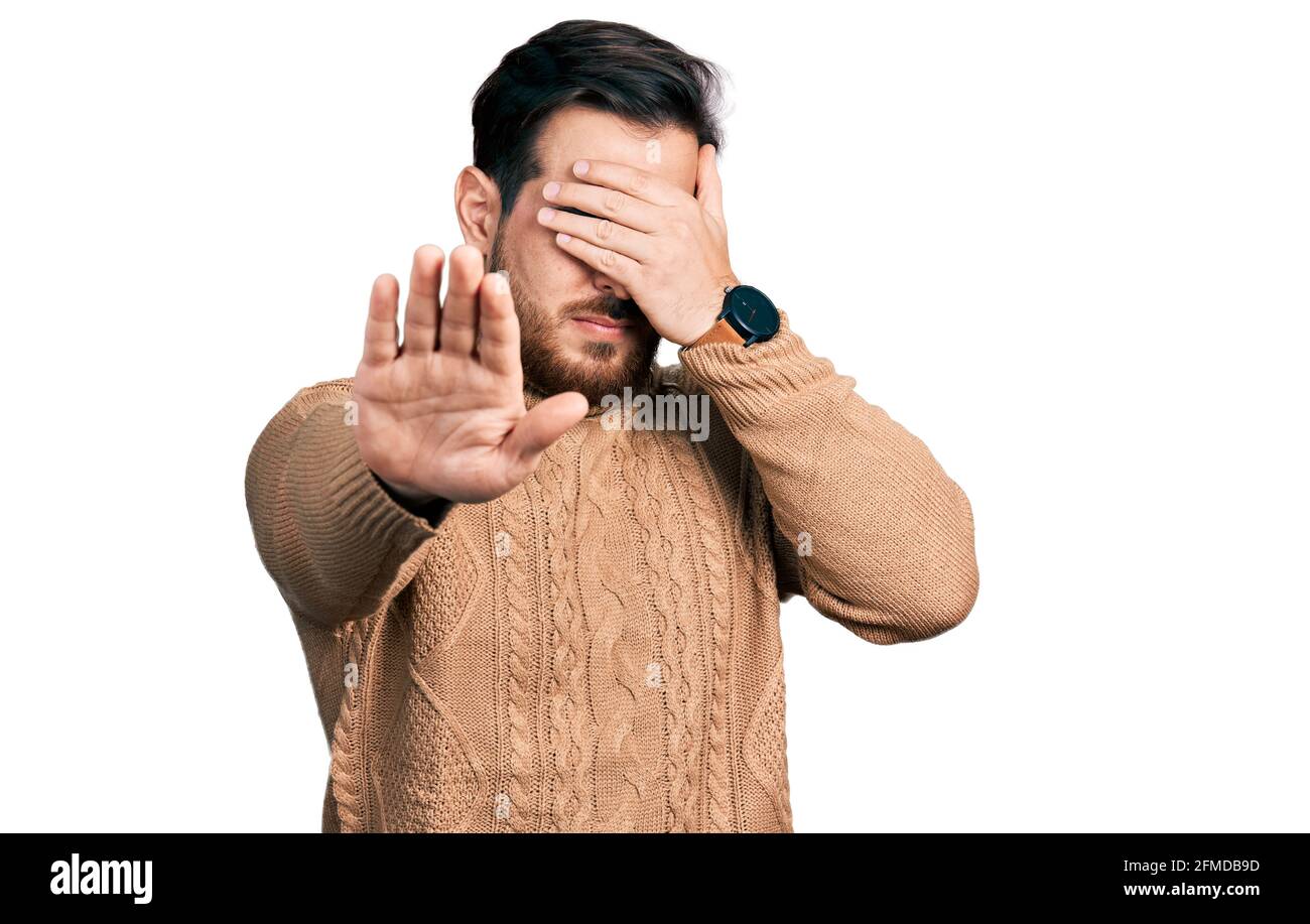 Young hispanic man wearing casual clothes covering eyes with hands and ...