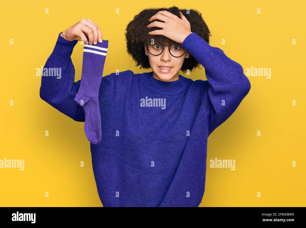 Young hispanic girl holding sporty sock stressed and frustrated with ...