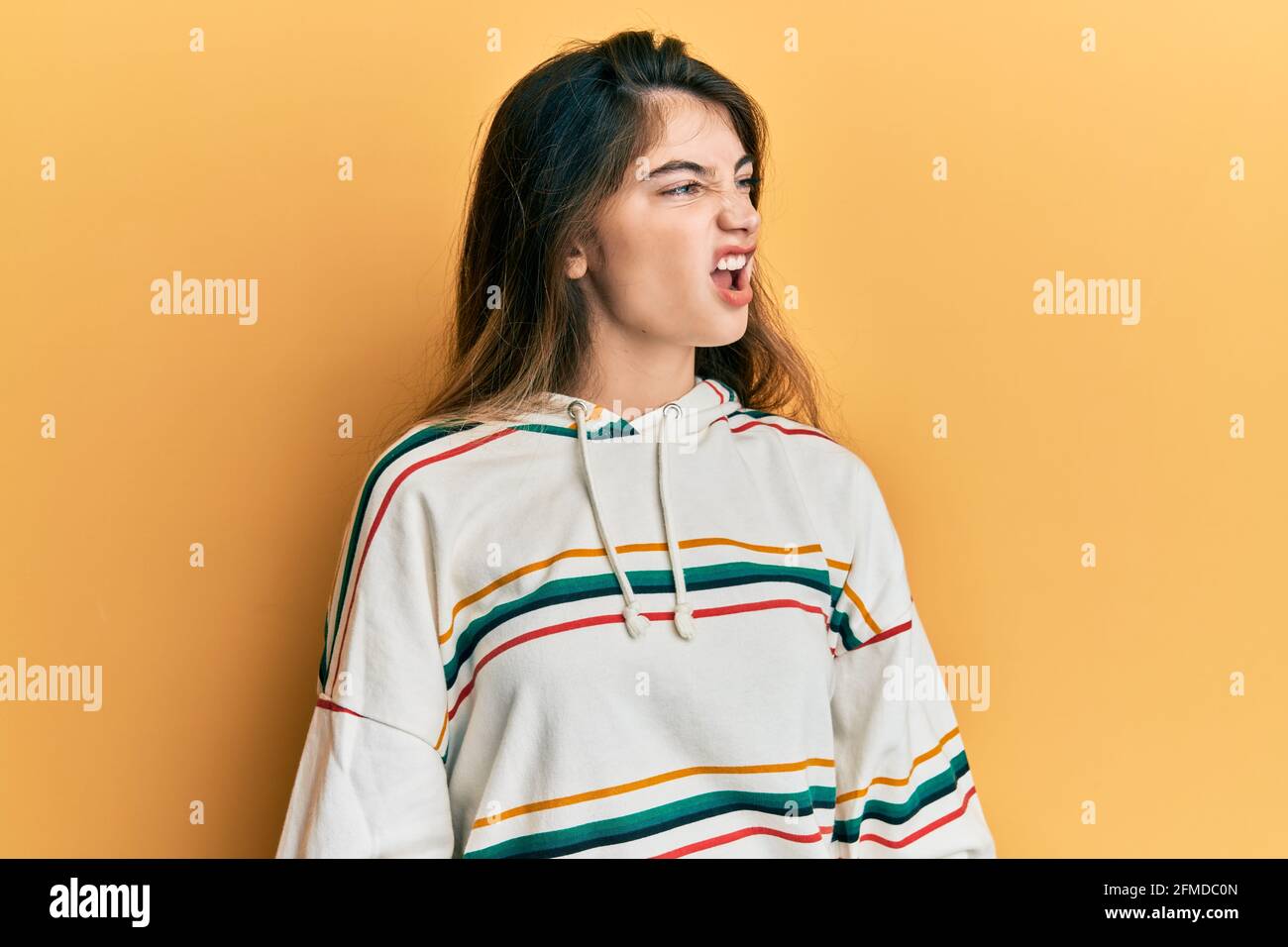 Young caucasian woman wearing casual clothes angry and mad screaming ...