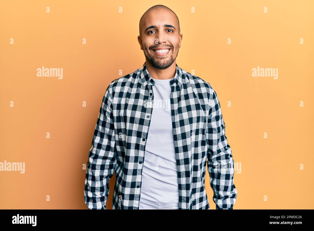 Hispanic adult man wearing casual clothes with a happy and cool smile ...