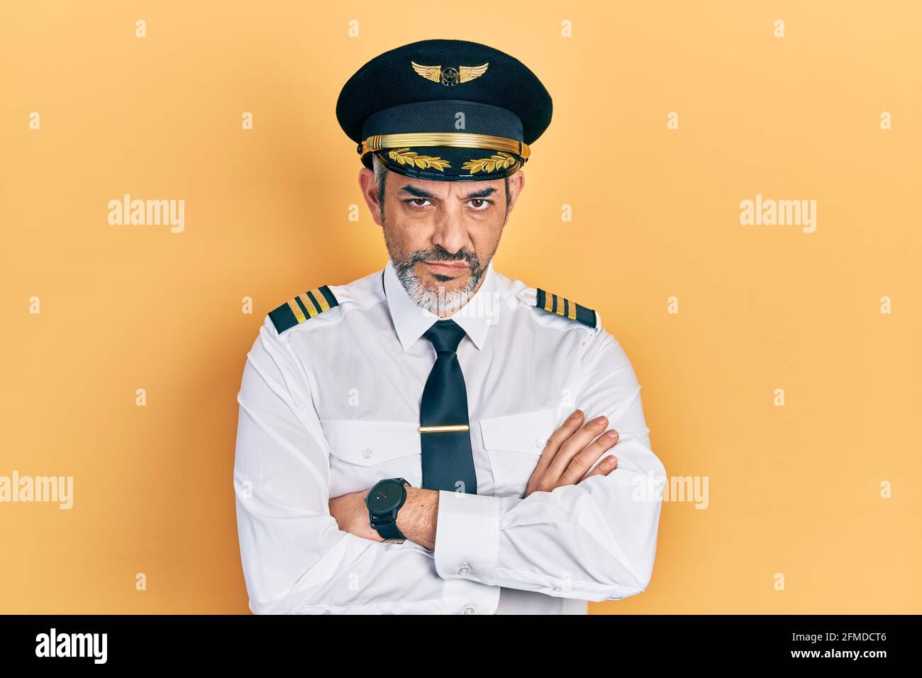 Handsome middle age man with grey hair wearing airplane pilot uniform ...