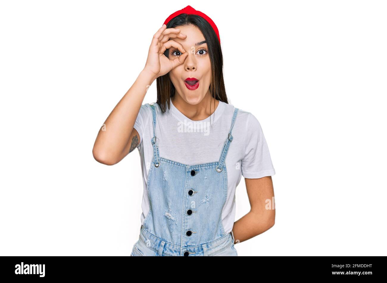 Young hispanic girl wearing casual clothes doing ok gesture shocked ...